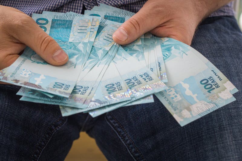 A Man Holding in His Hand a Bundle of High-value Brazilian Money Stock ...