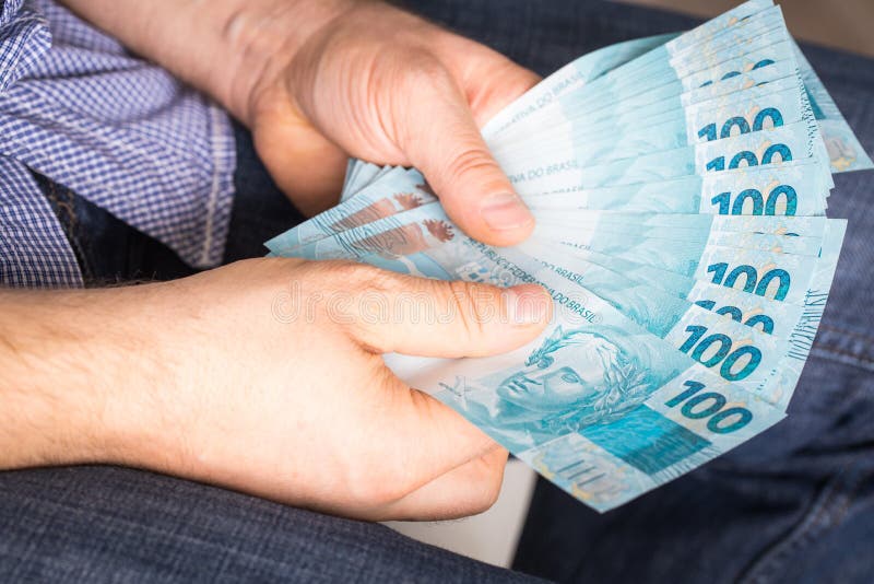 A Man Holding in His Hand a Bundle of High-value Brazilian Money Stock ...