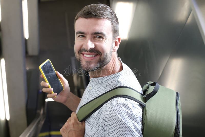 Man Holding His Smartphone while Using the Escalators Stock Photo ...