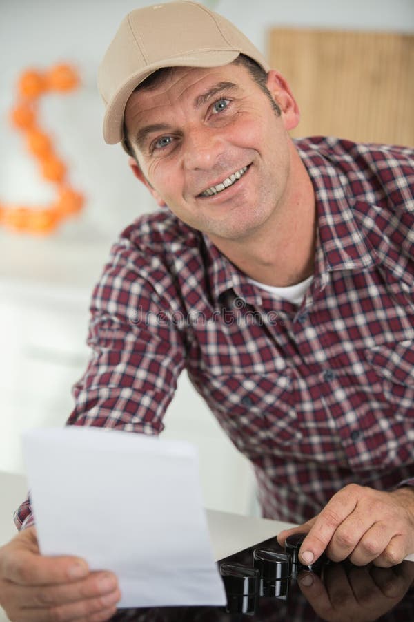 Man Holding Instrucitons for Installing New Hob Stock Image - Image of ...