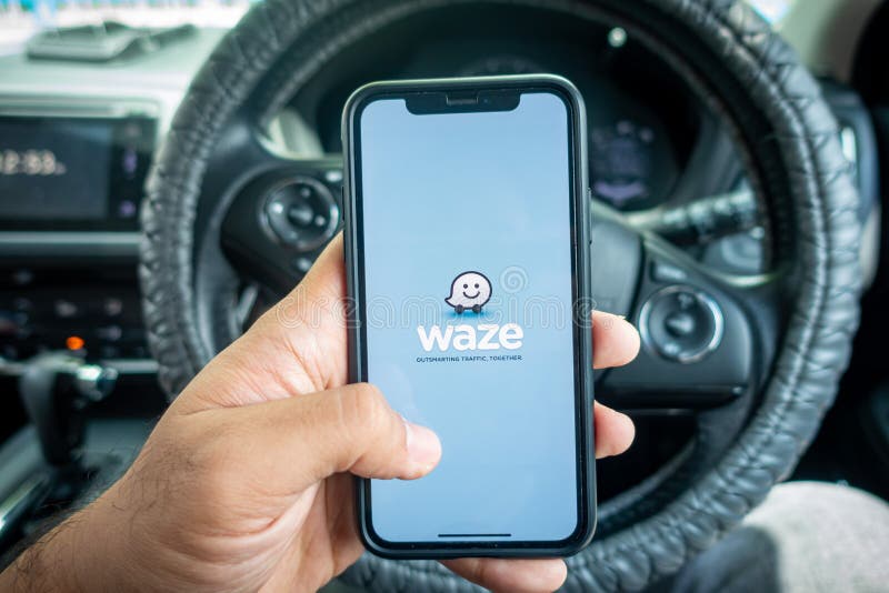 A Man Holding the IPhone X with Waze Navigation App Inside the Car ...