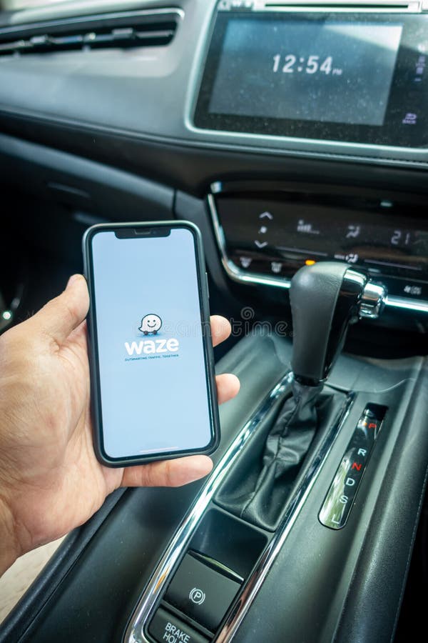 A Man Holding the IPhone X with Waze Navigation App Inside the Car ...