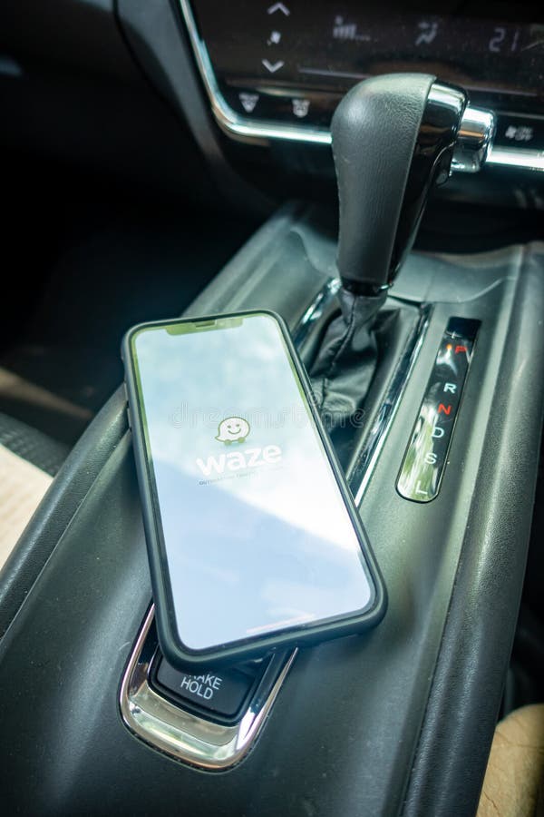 A Man Holding the IPhone X with Waze Navigation App Inside the Car ...