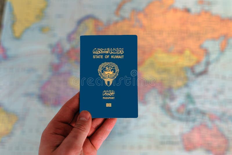 Man Holding Kuwait Passport in Hand and World Map in Background Stock ...