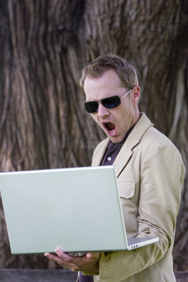 Man Holding Laptop Computer Stock Photo - Image of disbelief, young ...