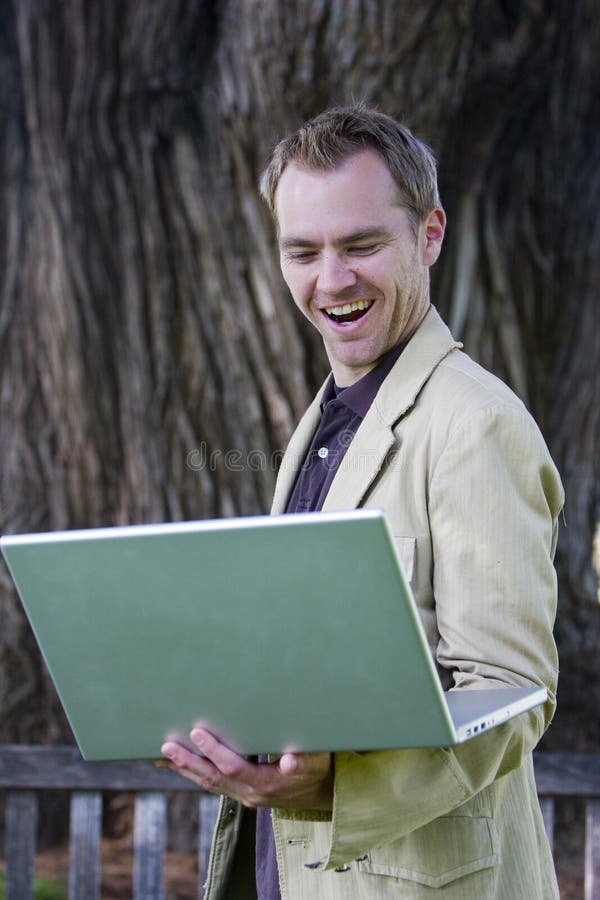 Man Holding Laptop Computer Stock Image - Image of work, park: 9812601