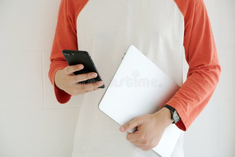 Man Holding Laptop Computer and Using Smart Phone, People and Te Stock ...