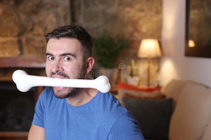 Man Holding Large Bone in Mouth Stock Image - Image of evolution, broth ...