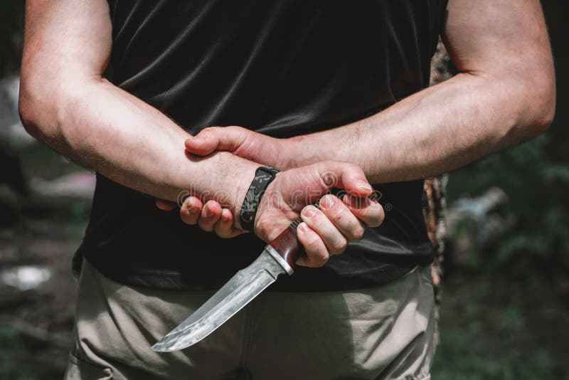 A Man Holding a Large Sharp Knife in His Hand Stock Photo - Image of ...