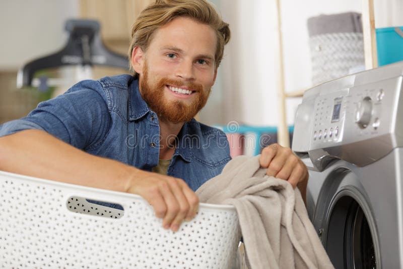 Man Holding Laundry Basket Putting Washing in Washing Machine Stock ...