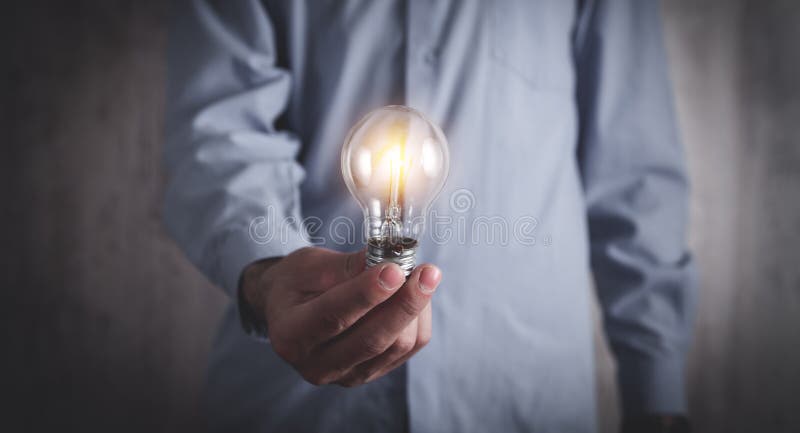 Man Holding Light Bulb. Concept of Inspiration and Creativity Stock ...