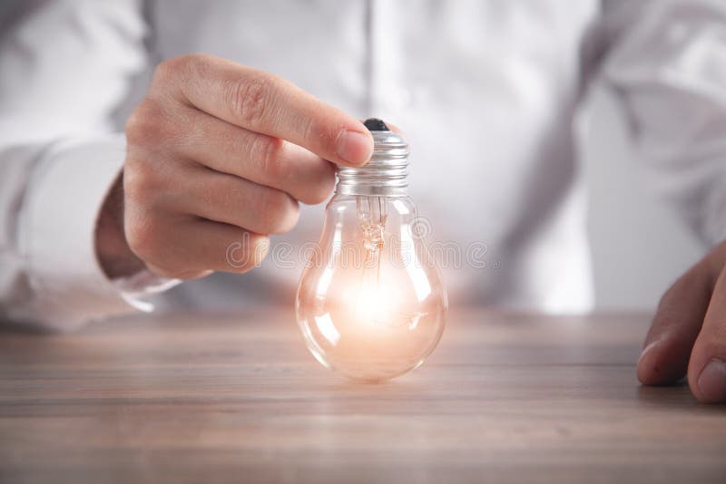 Man Holding Light Bulb. Concept of Inspiration and Creativity Stock ...