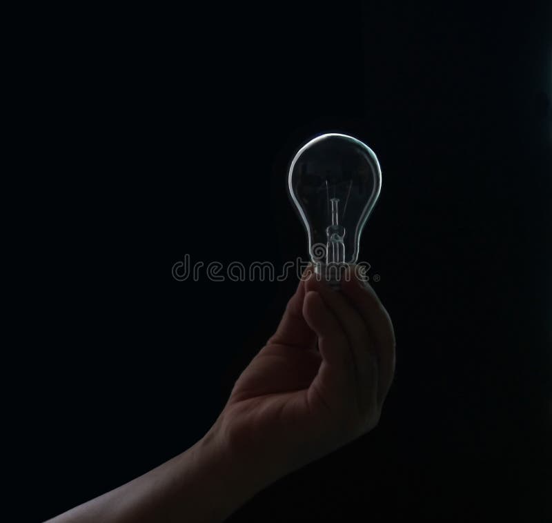 Man Holding Light Bulb in Hand Isolate on Black Stock Photo - Image of ...