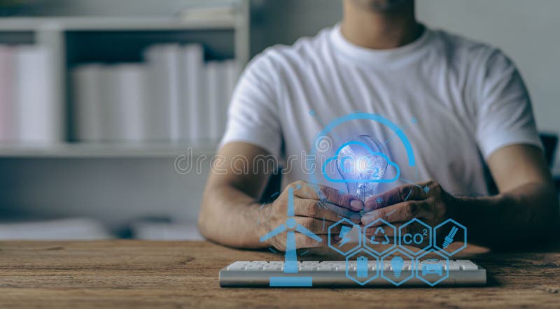 Man Holding Light Bulb with Windmill Icon, Energy Source, Global ...