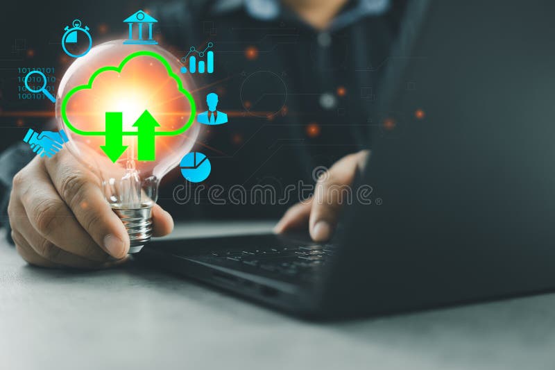 Man Holding a Light Bulb while Working on the Computer To Think and ...