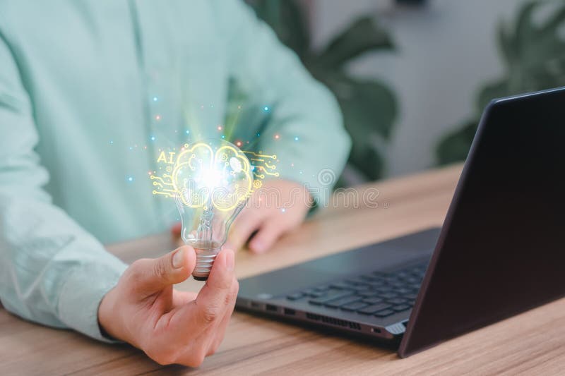 Man Holding a Light Bulb while Working on the Computer To Think and ...