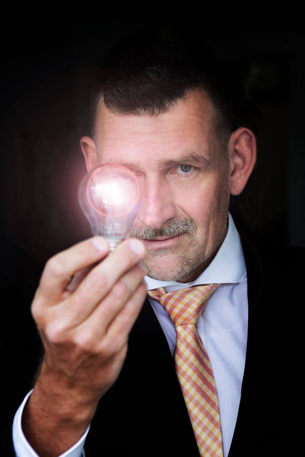 Man holding a lightbulb stock photo. Image of leadership - 60204406