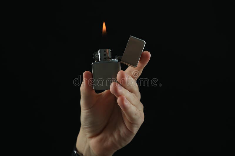 Man Holding Lighter with Burning Flame on Black Background, Closeup ...