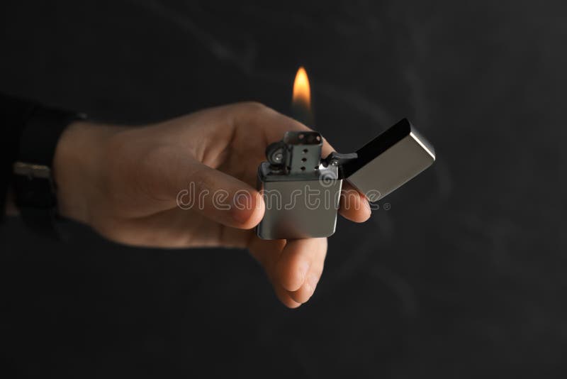Man Holding Lighter with Burning Flame on Dark Background, Closeup ...