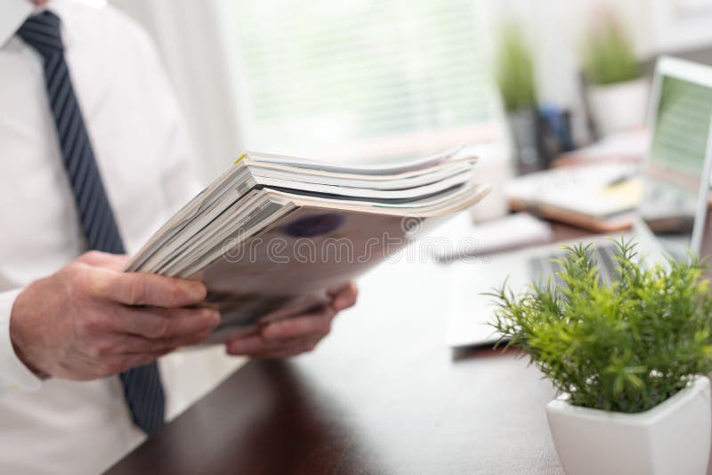 Man holding magazines stock image. Image of pile, information - 241382195