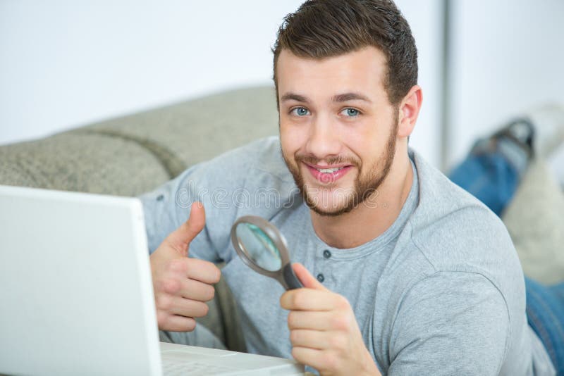 Man Holding Magnifying Glass and Using Laptop Stock Image - Image of ...