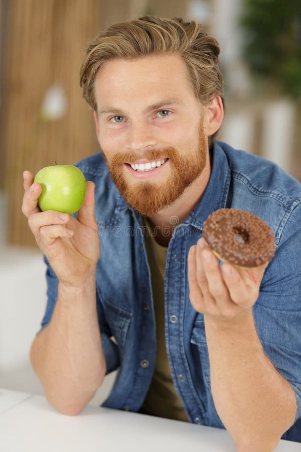 Man Holding and Making Choice between Healthy or Junk-food Stock Photo ...