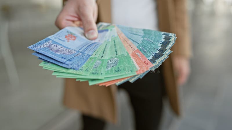Man Holding Malaysian Ringgit Banknotes on an Urban Street Stock Photo ...