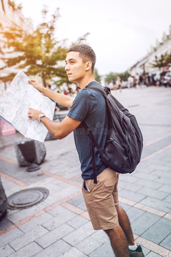 Man Holding Map and Looking Around in Direction Stock Photo - Image of ...