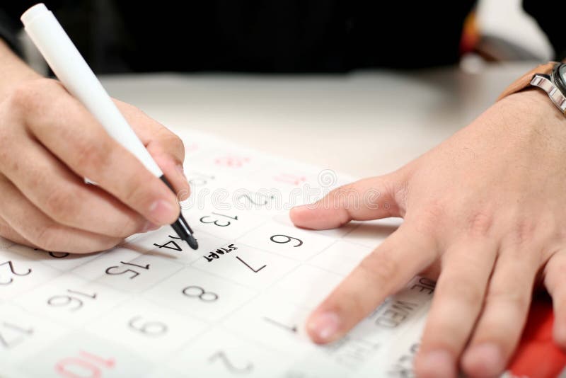Man Hand with Calendar and Black Marker. Concept Mark on the Calendar ...