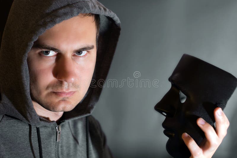 The Man is Holding a Mask in His Hand Stock Photo - Image of crime ...