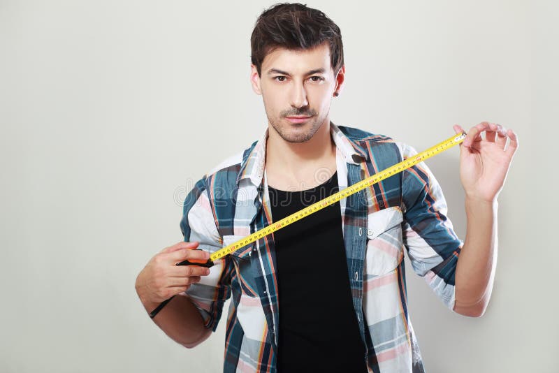 Man holding measure tape stock photo. Image of adult - 94843622