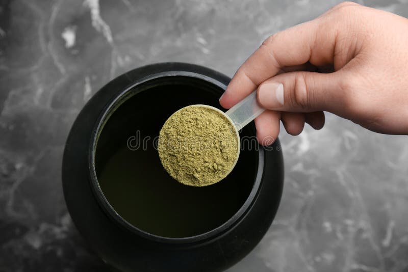 Man Holding Measuring Spoon with Hemp Protein Powder Over Jar Stock ...