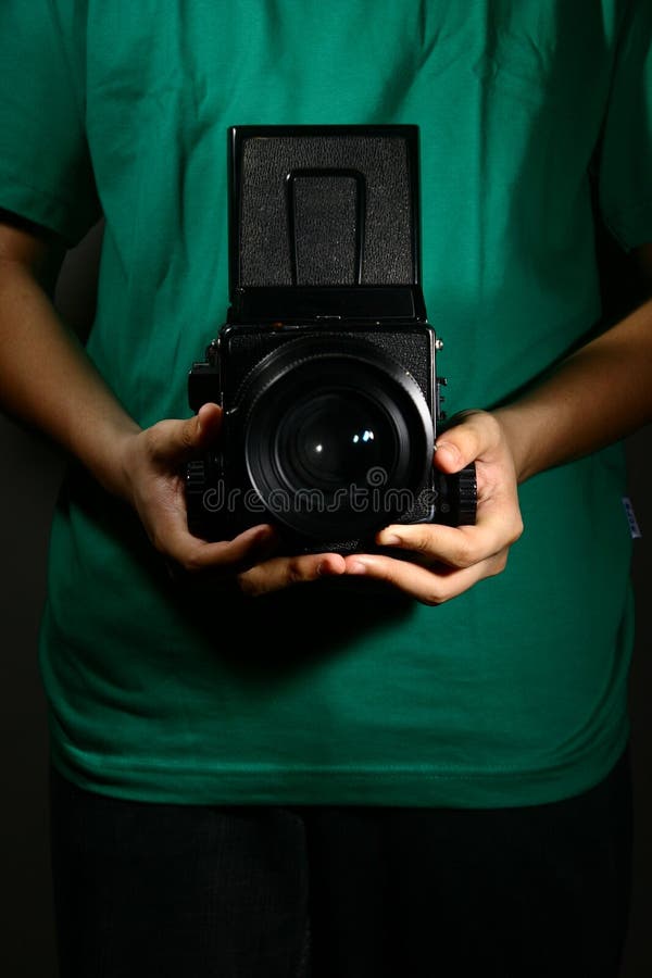 Man Holding a Medium Format Film Camera Stock Photo - Image of green ...