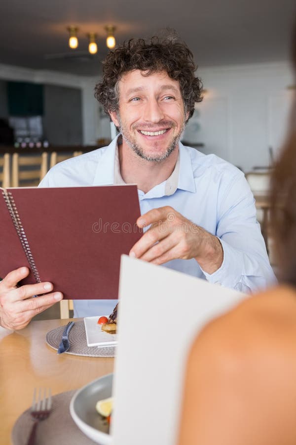Man Holding Menu Card and Smiling Stock Photo - Image of indoors ...