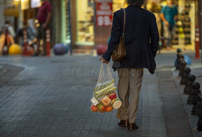 Man is Holding Mesh Shopping Bag in the Street Stock Photo - Image of ...