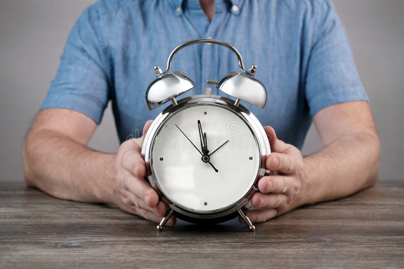 Man Holding Metal Alarm Clock in His Hands Stock Image - Image of alert ...
