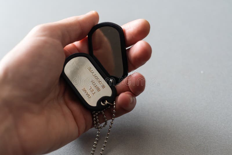 Man Holding Military ID Tag on White Background, Closeup Stock Image ...