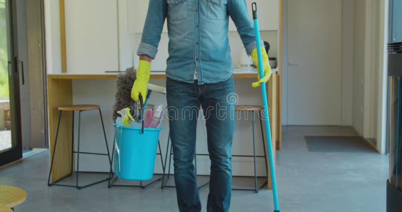 Man Holding Mop and Plastic Bucket with Brushes, Gloves and Detergents ...