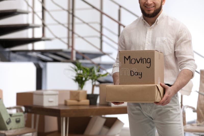 Man Holding Moving Boxes in New Office. Space for Text Stock Photo ...