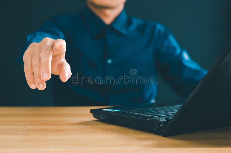 The Man is Holding a Notebook in His Hand, Pointing To the Screen ...