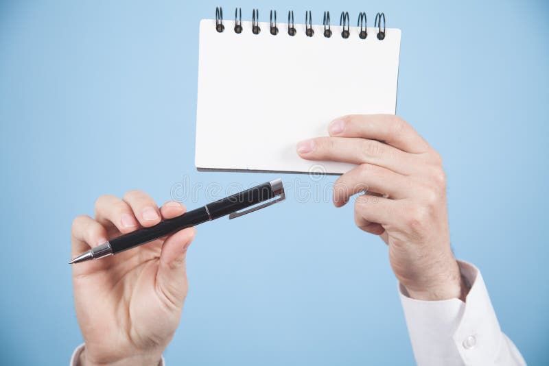 Man Holding Notepad and Pen in Office Stock Photo - Image of studying ...