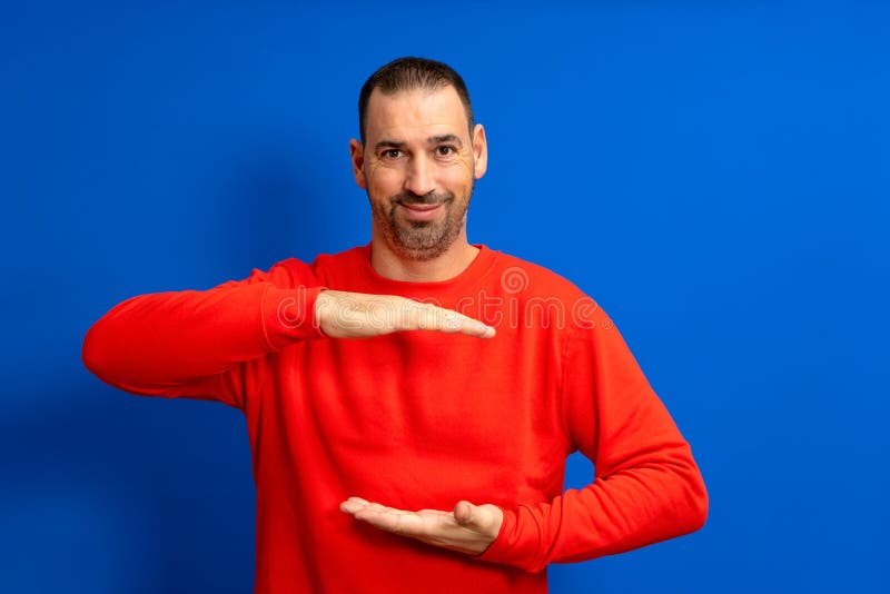 A Man Holding an Object with Both Hands in Front of Him, Displaying ...