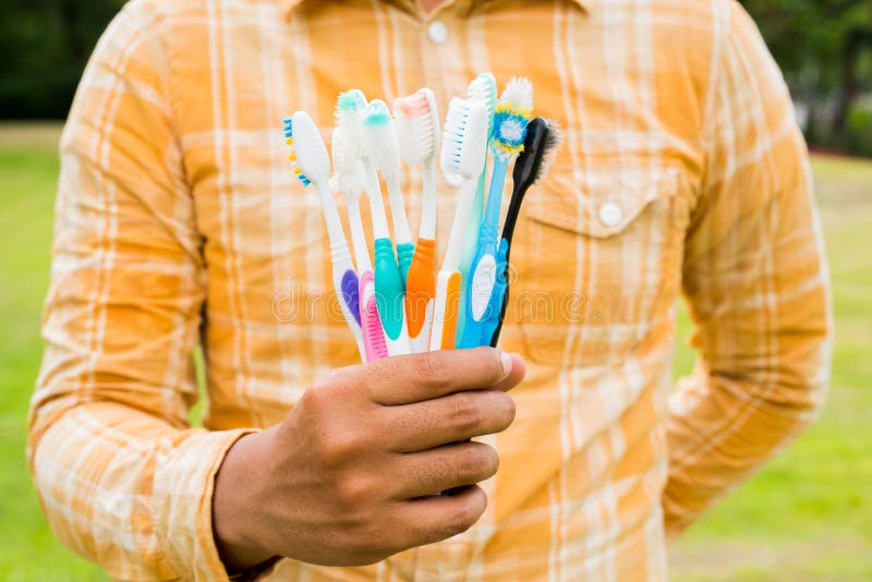 Man Holding Old Toothbrushes Stock Photo - Image of hold, clean: 151920972