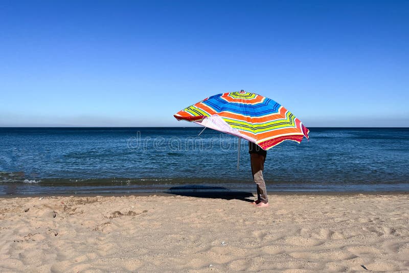 A Man Holding an Open Parasol on the Beach Stock Image - Image of coast ...