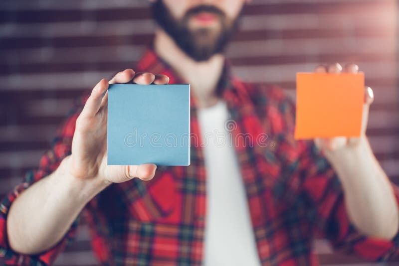 Man Holding Orange and Blue Adhesive Notes Stock Photo - Image of ...