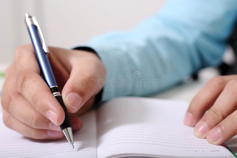 Man Holding Pen in Hand with Notebook on the Table Stock Photo - Image ...