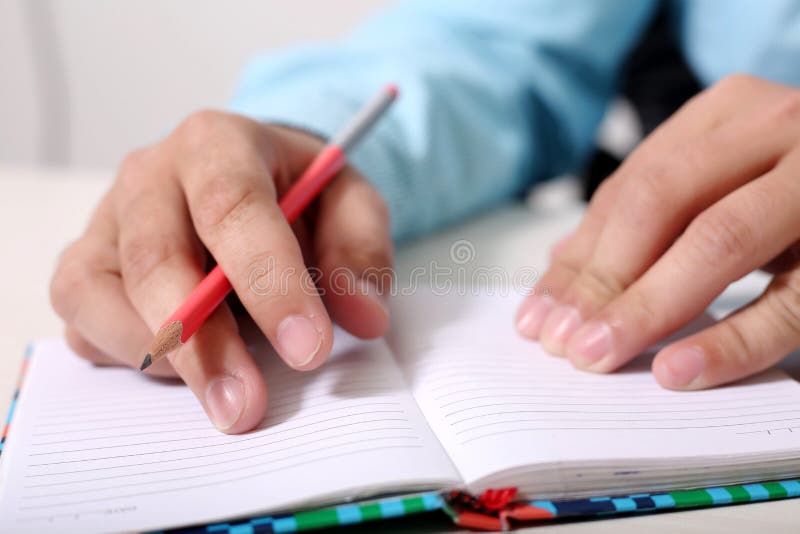 Man Holding Pencil in Hand with Notebook on the Table Stock Photo ...