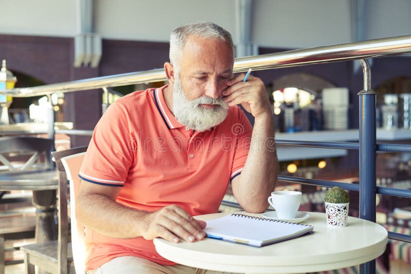 Man Holding Pencil and Looking at Empty Notepad Stock Photo - Image of ...