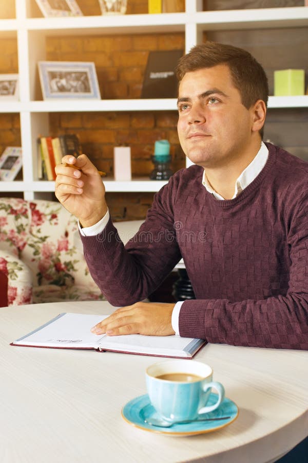 Man Holding Pencil and Writing on a Paper in the Diary Stock Image ...