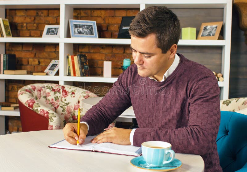 Man Holding Pencil and Writing on a Paper in the Diary Stock Photo ...